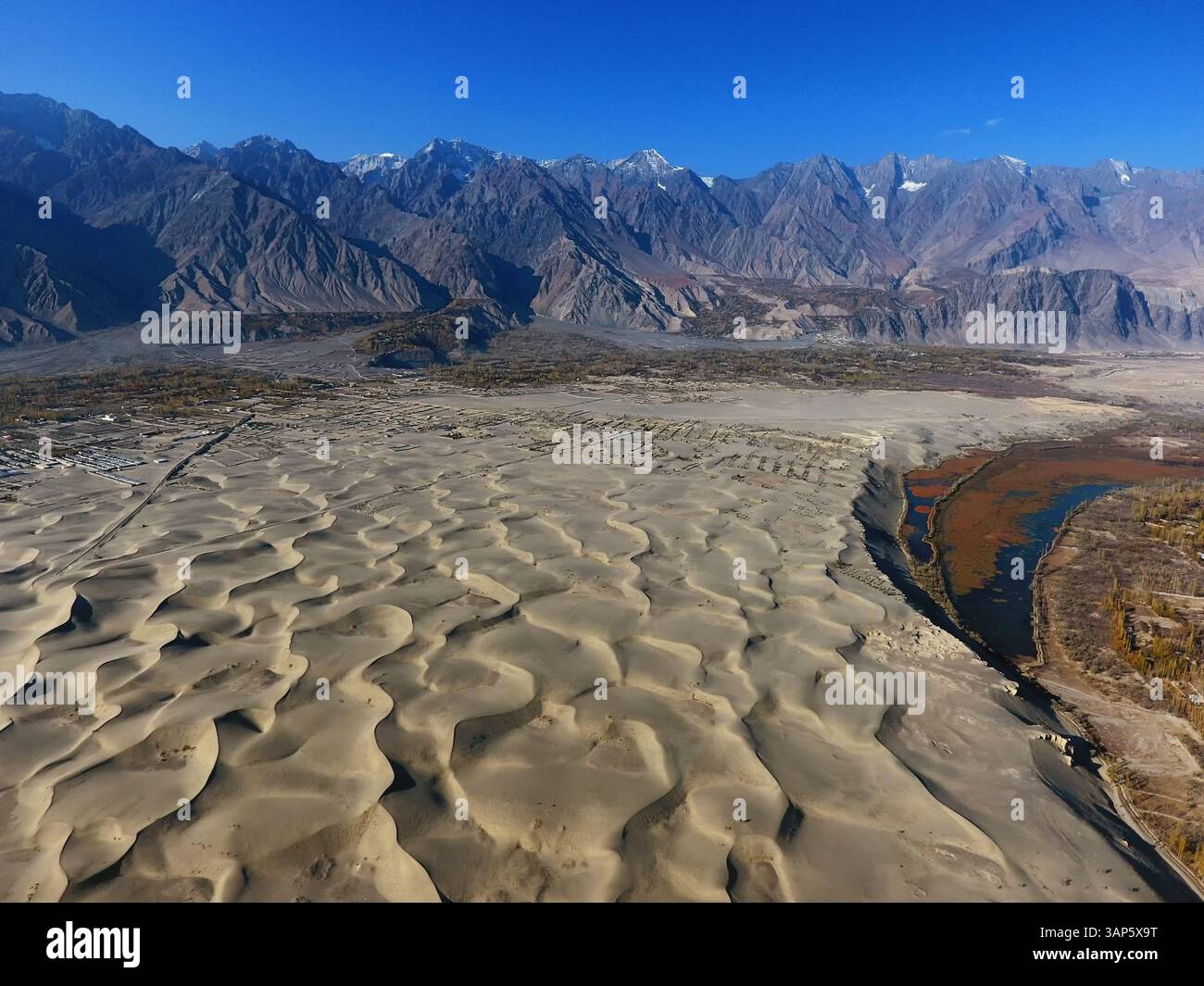 Aerial view of majestic Katpana Desert with sand dunes and mountains ...