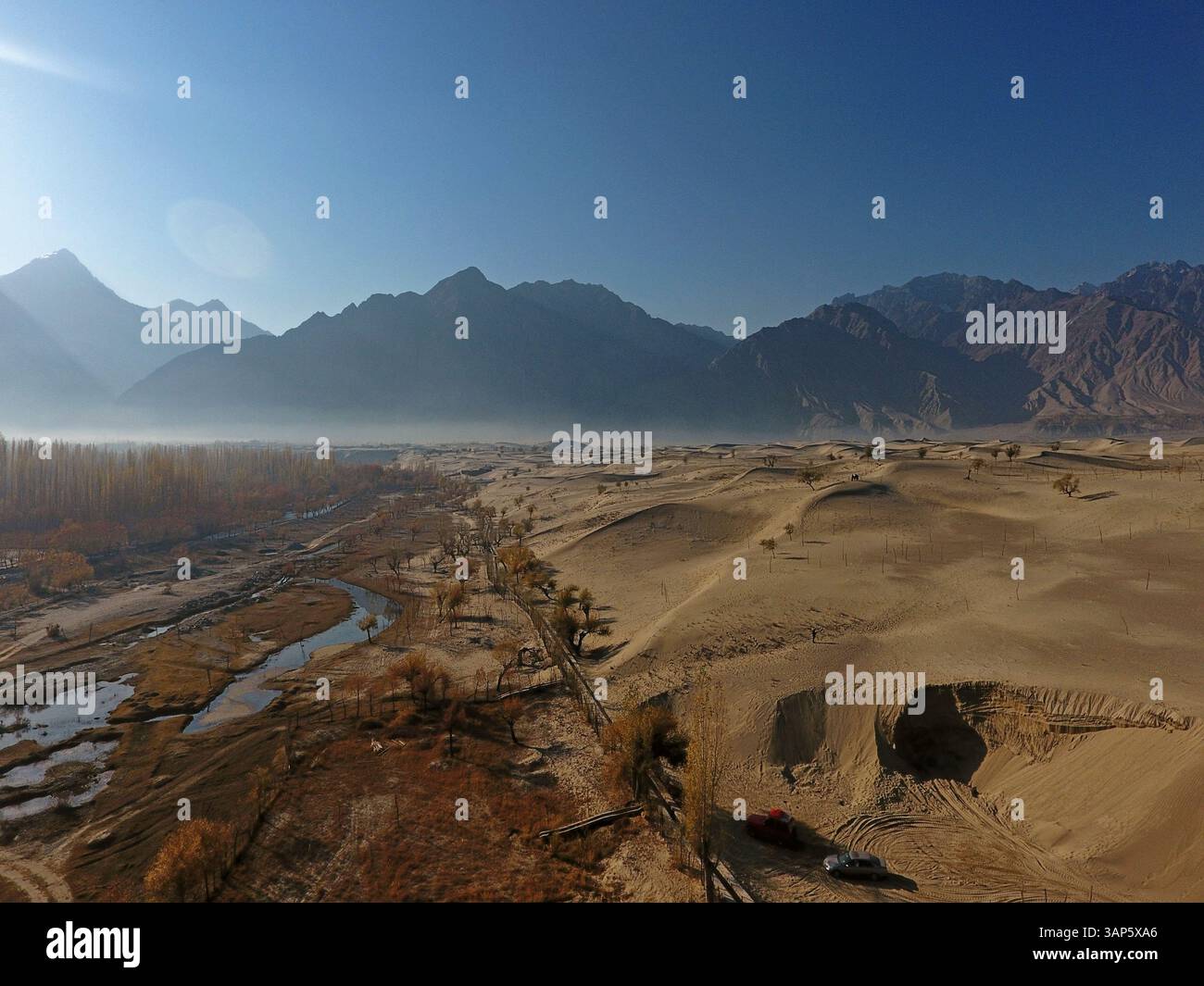 Aerial view of majestic Katpana Desert with mountains, sand dunes, and ...