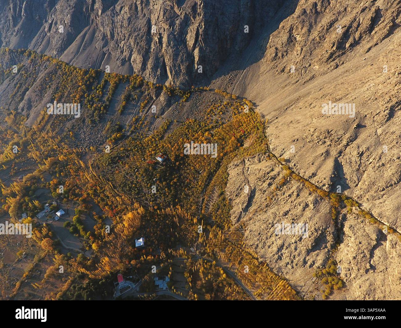 Aerial view of remote valley with majestic mountains and golden hour ...