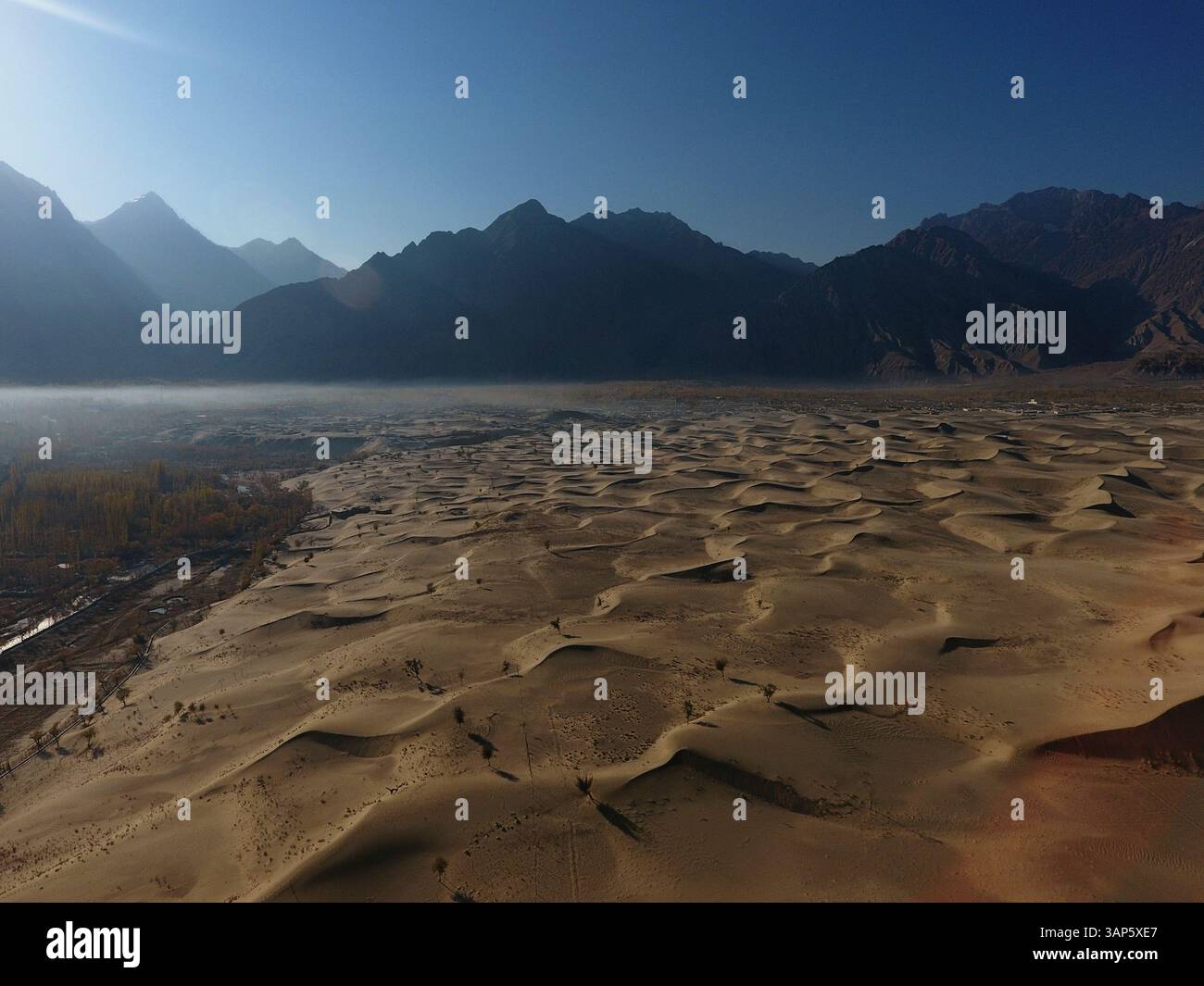 Aerial view of Katpana Desert with majestic mountains and vast sand ...