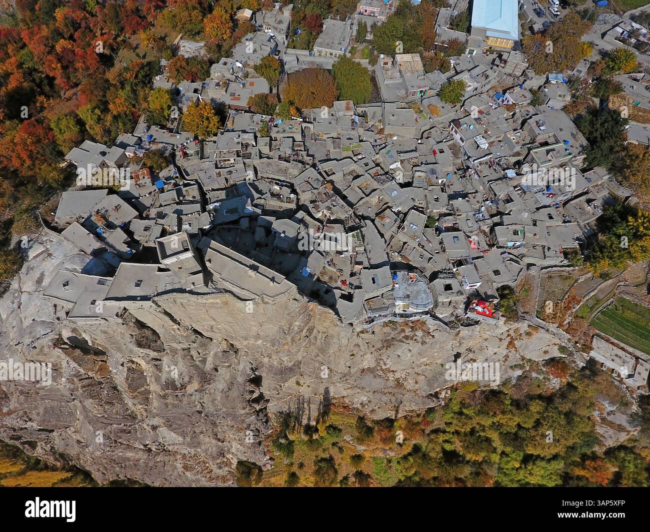 Aerial view of traditional village nestled in cliff with autumn colors ...
