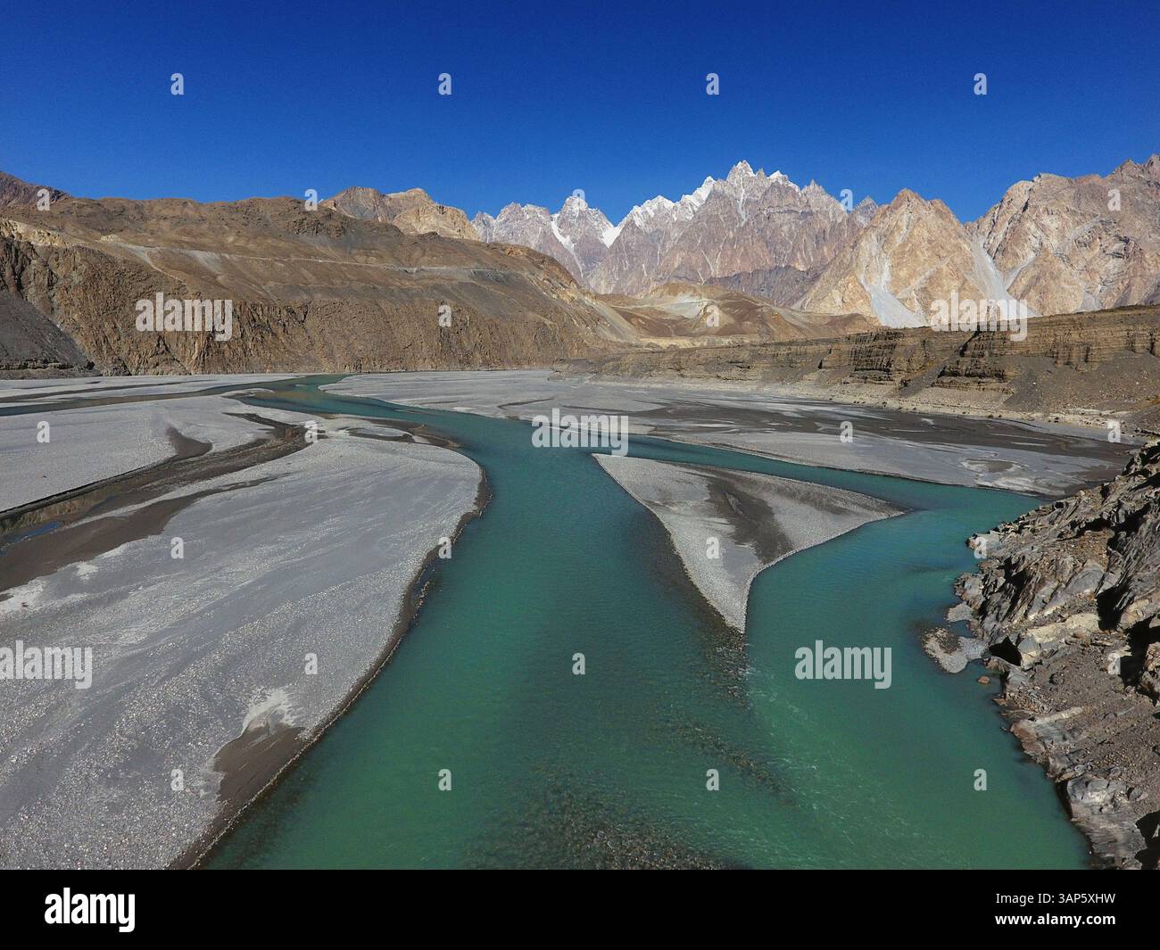 Aerial view of majestic mountains and serene river in Hunza, Passu ...