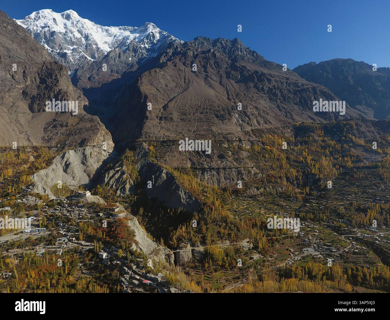 Aerial view of majestic mountains and remote village in Hunza Valley ...