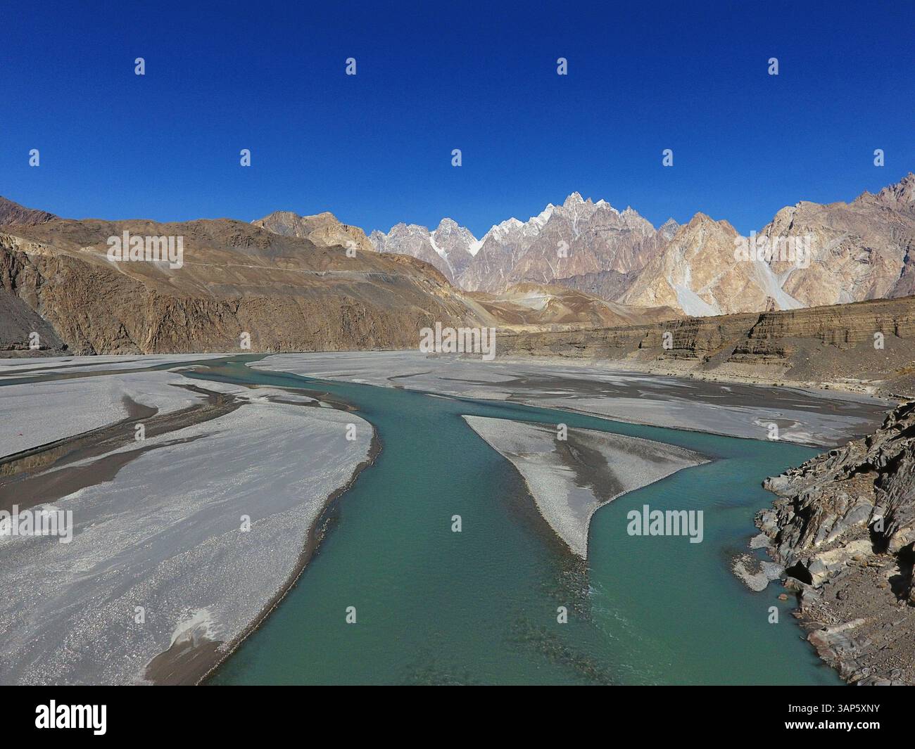 Aerial view of majestic mountains, tranquil river, and remote valley in ...