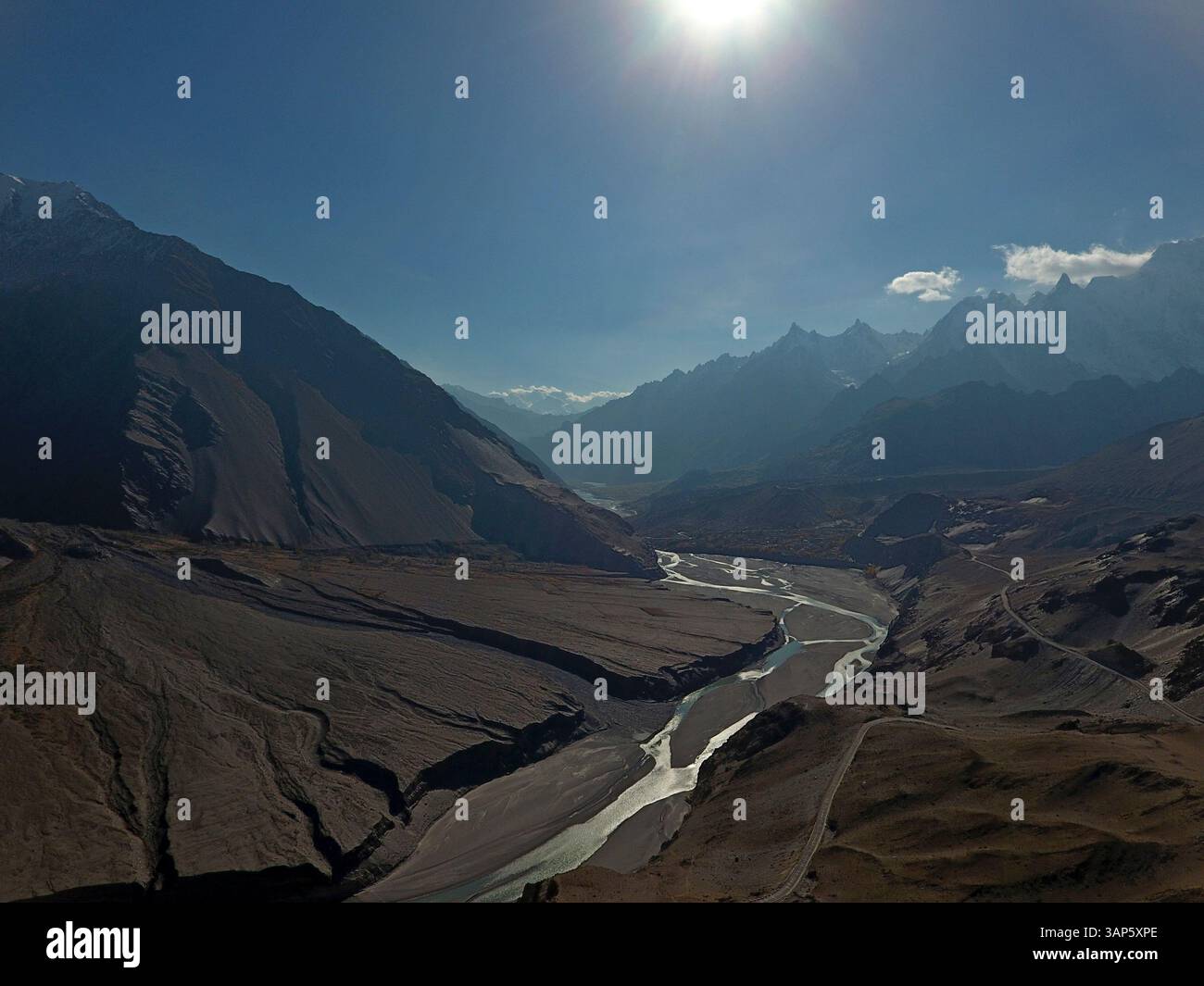Aerial view of majestic peaks and glacial river in snow-covered Hunza ...