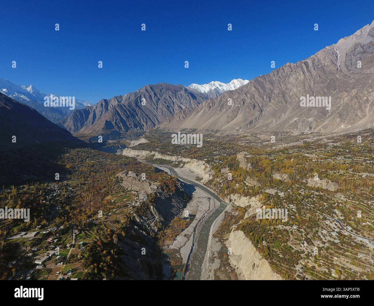 Aerial view of majestic Himalayan mountains and serene river in autumn ...