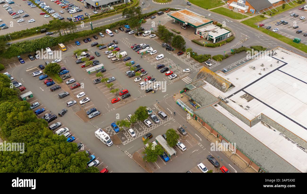 Aerial view of a busy morrisons supermarket carpark with cars and trees ...