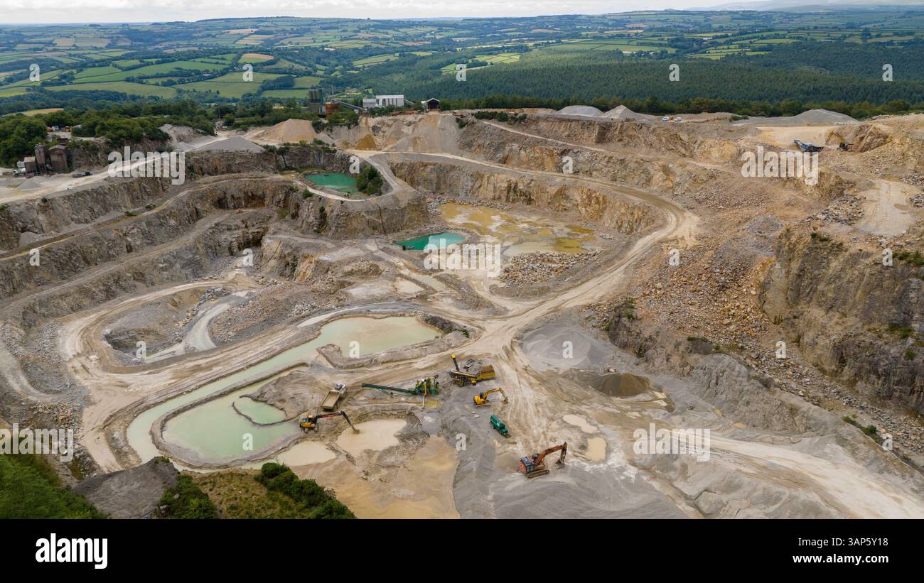 Aerial view of industrial quarry with heavy machinery and excavation ...