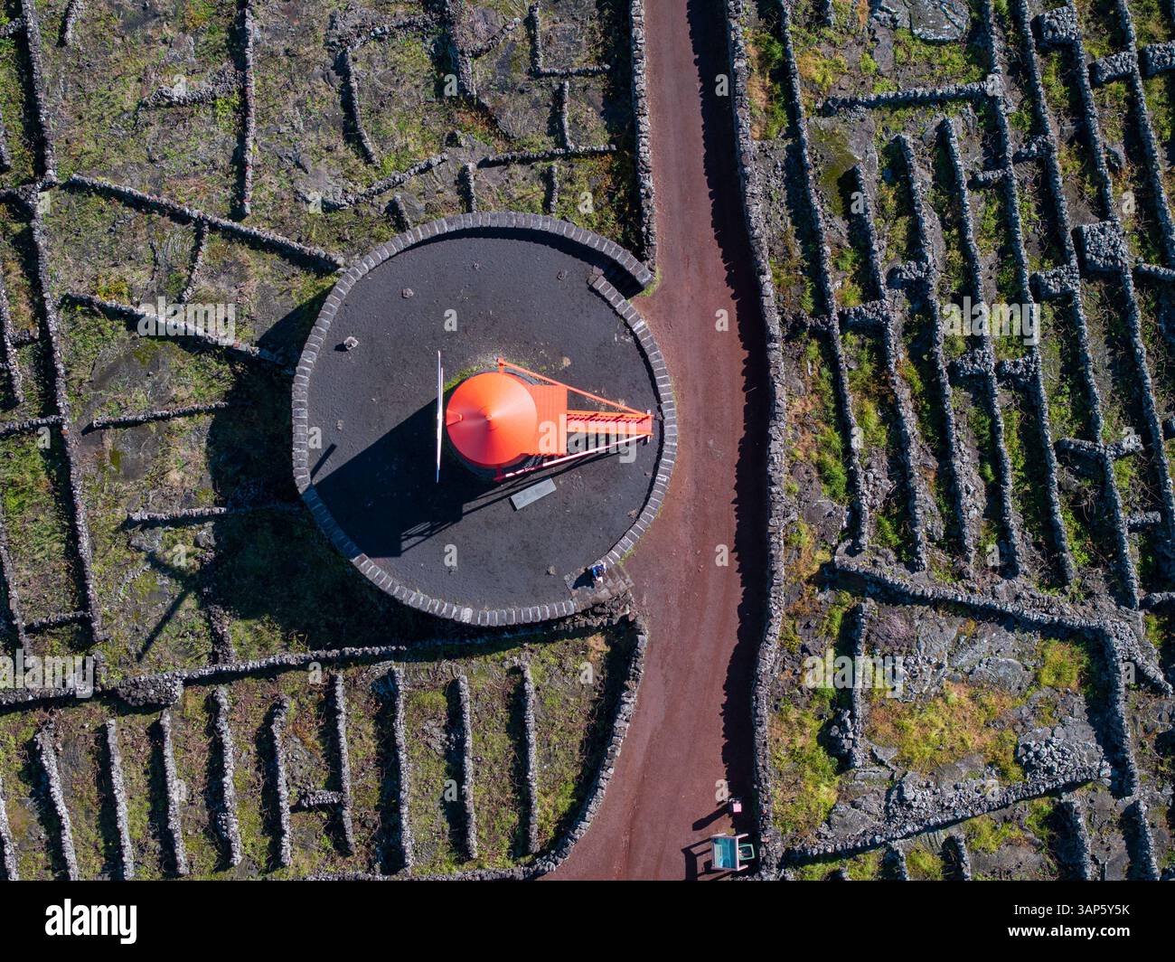 Aerial view of ancient volcanic vineyards with stone walls and a scenic ...
