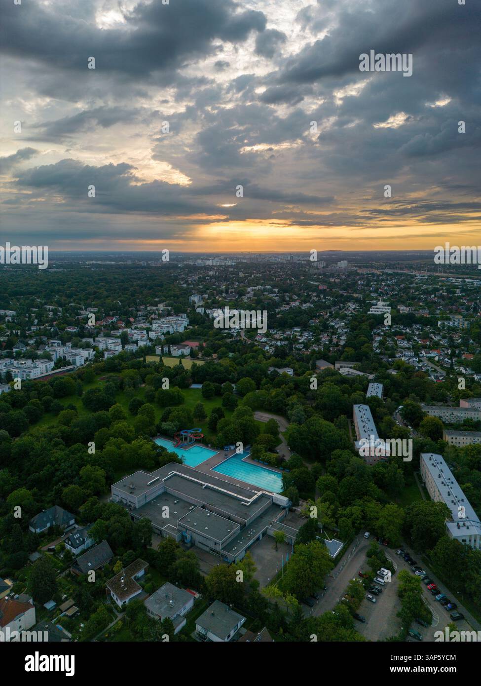 Aerial view of beautiful public pools surrounded by buildings and trees ...