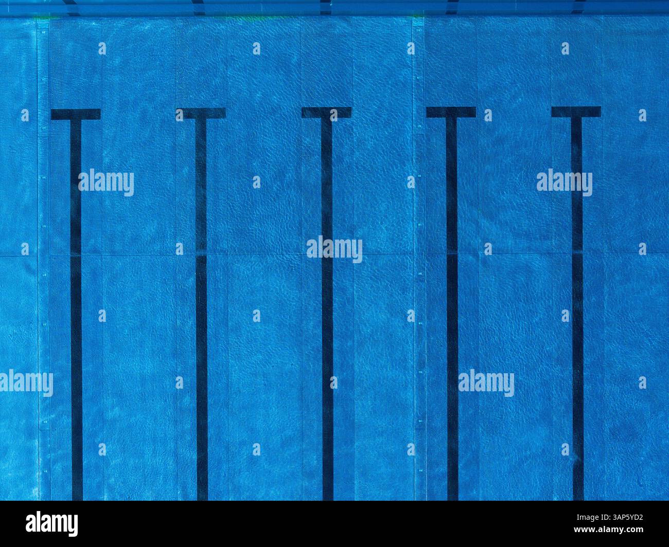 Aerial view of modern public pools with geometric swim lanes and clear ...