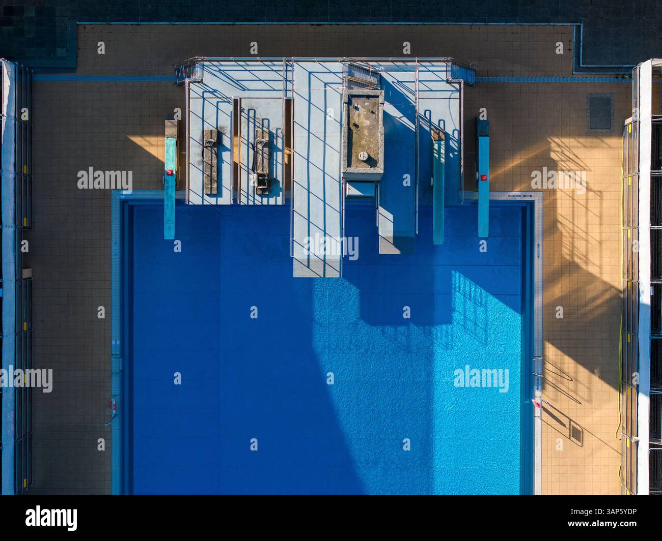Aerial view of public swimming pools with diving boards and geometric ...