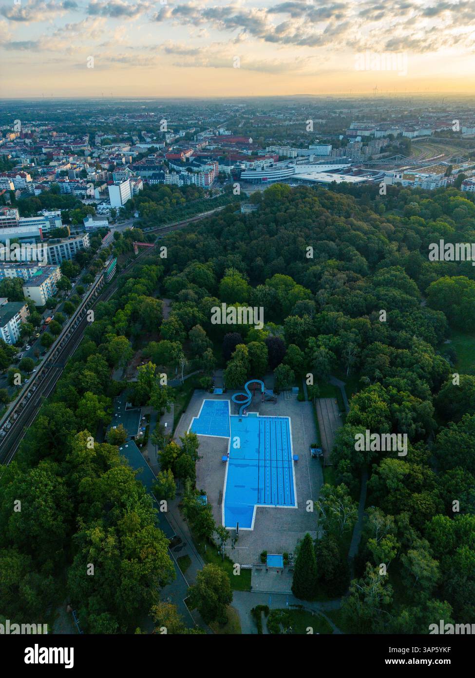 Aerial view of beautiful public pools surrounded by lush greenery and ...