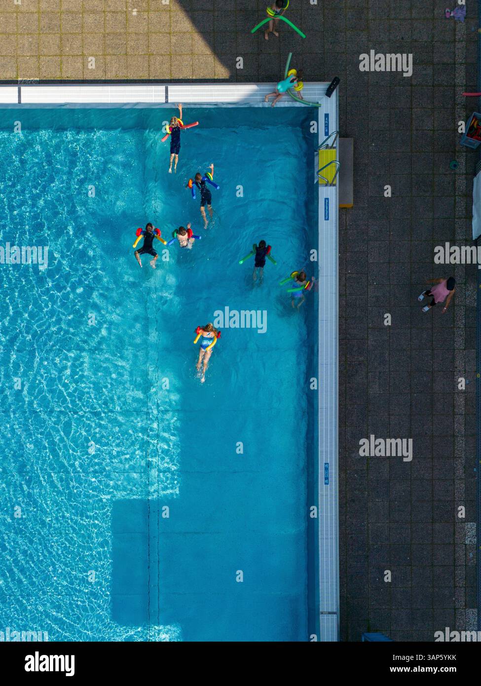Aerial view of public pools with people swimming under the sunny ...