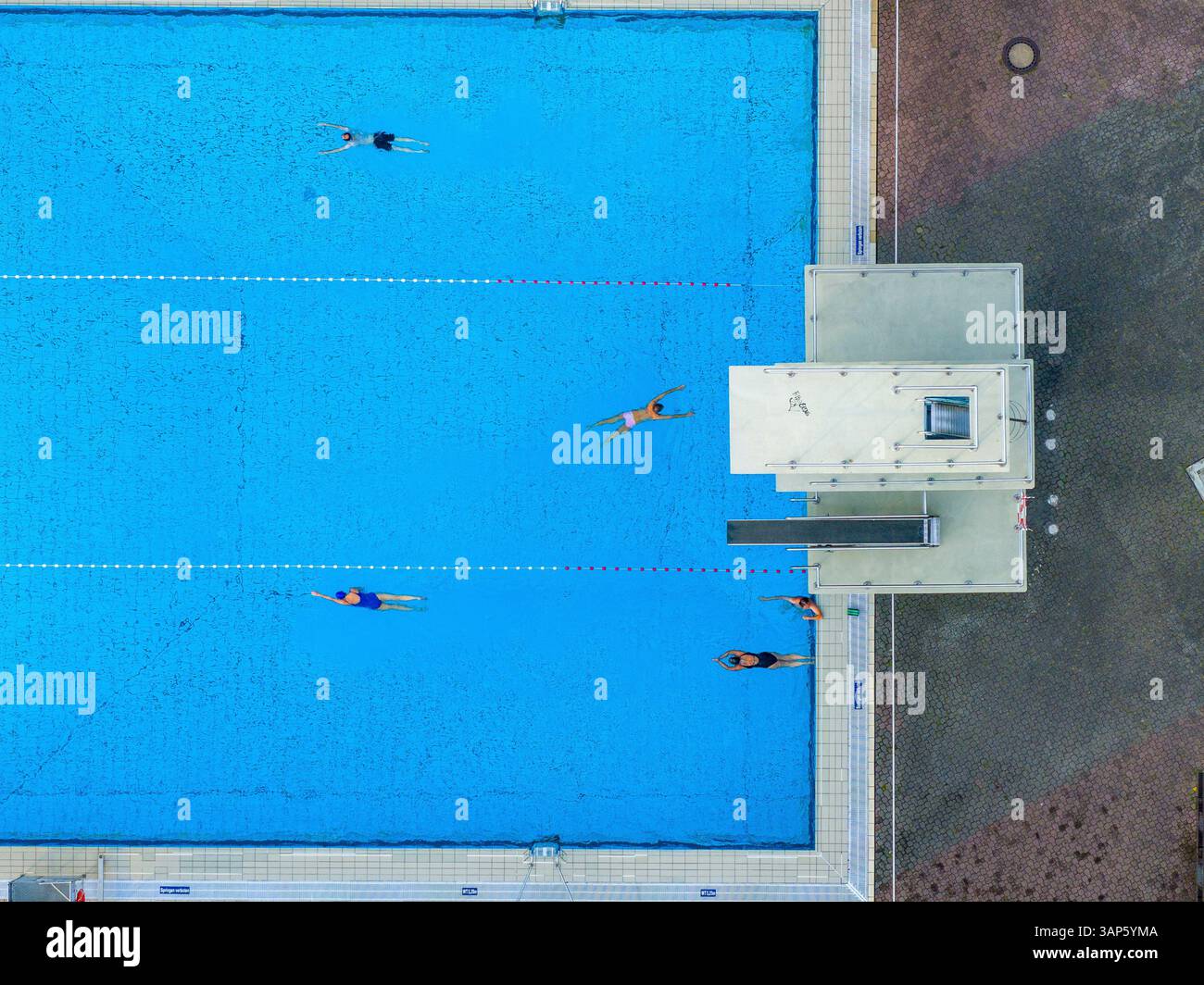 Aerial view of public pools with swimmers and diving board in Neukolln ...