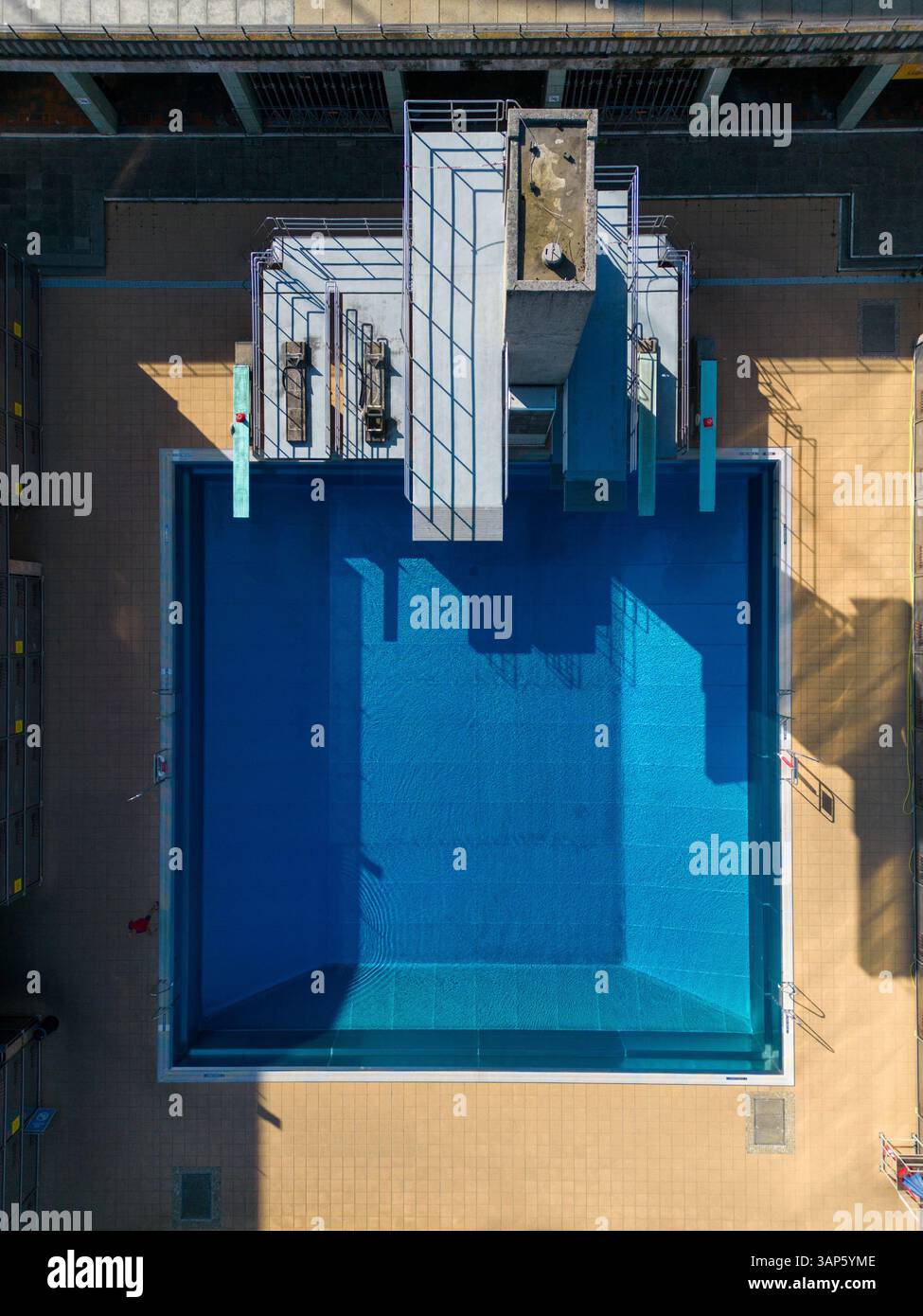Aerial view of modern public swimming pool with diving boards and ...