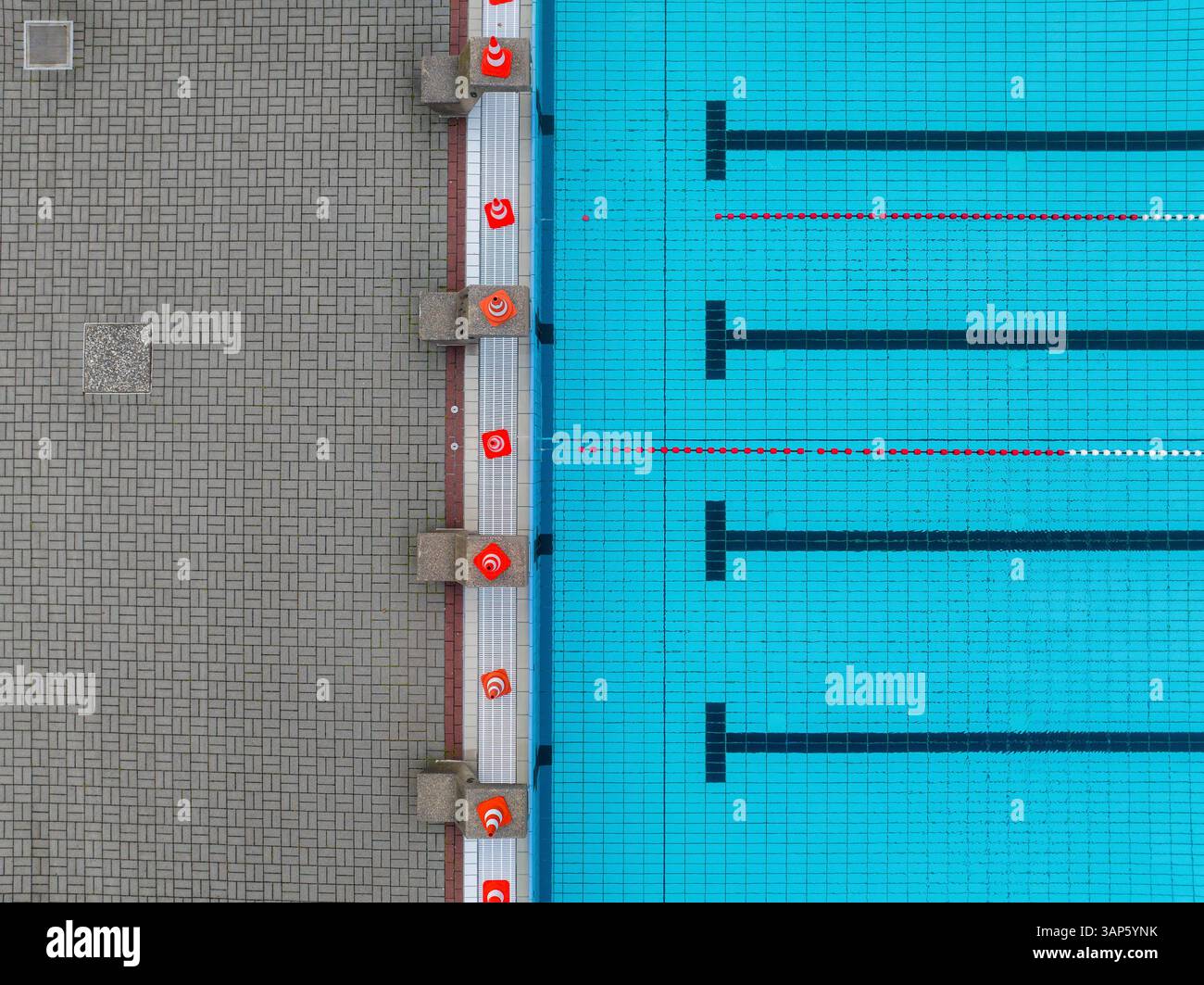 Aerial view of a tranquil public swimming pool with organized blue ...