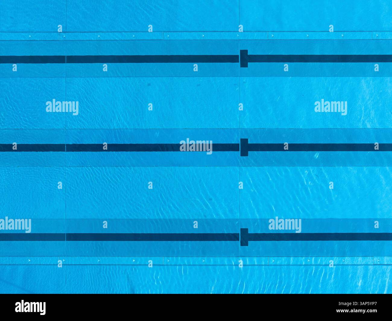 Aerial view of vibrant public swimming pools with clear water and ...