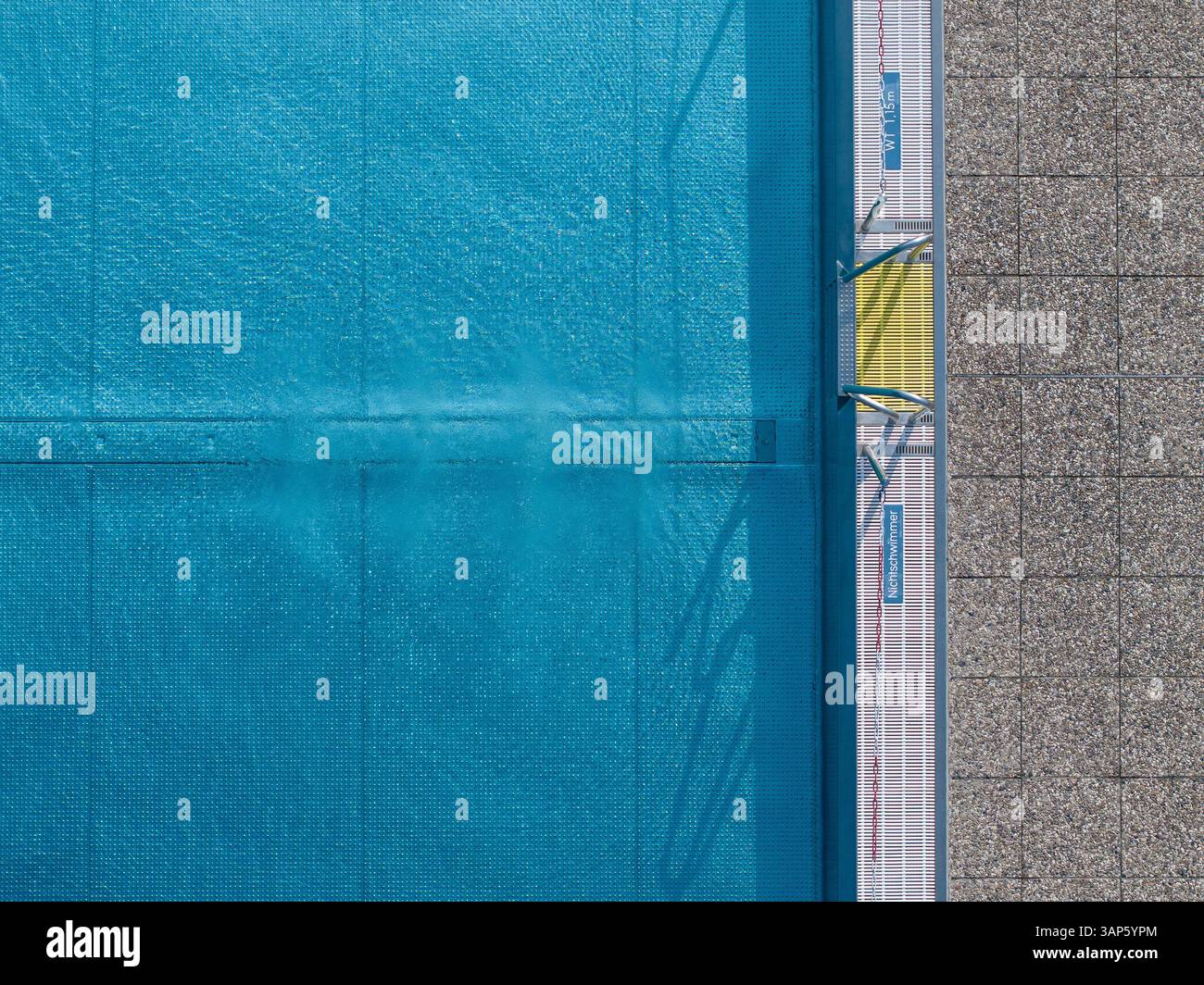 Aerial view of geometric public pools with clear blue water and ...