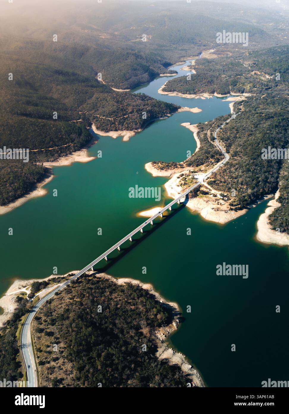 Aerial view of a suspended bridge and a beautiful landscape with lake ...