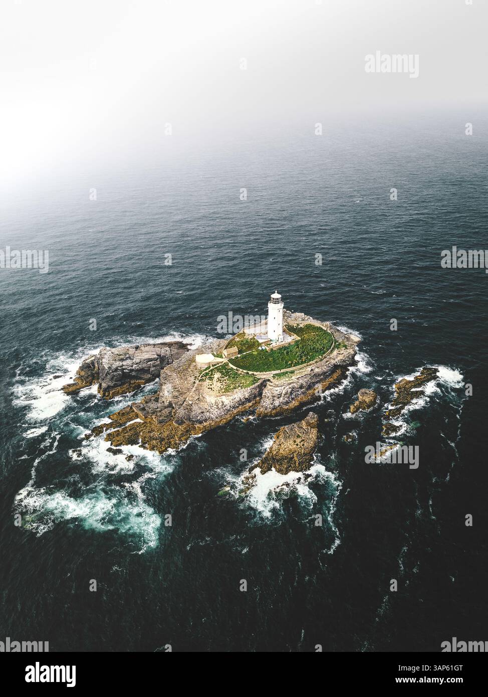 Aerial view of Godrevy Lighthouse, a solar powered tower on a tiny ...