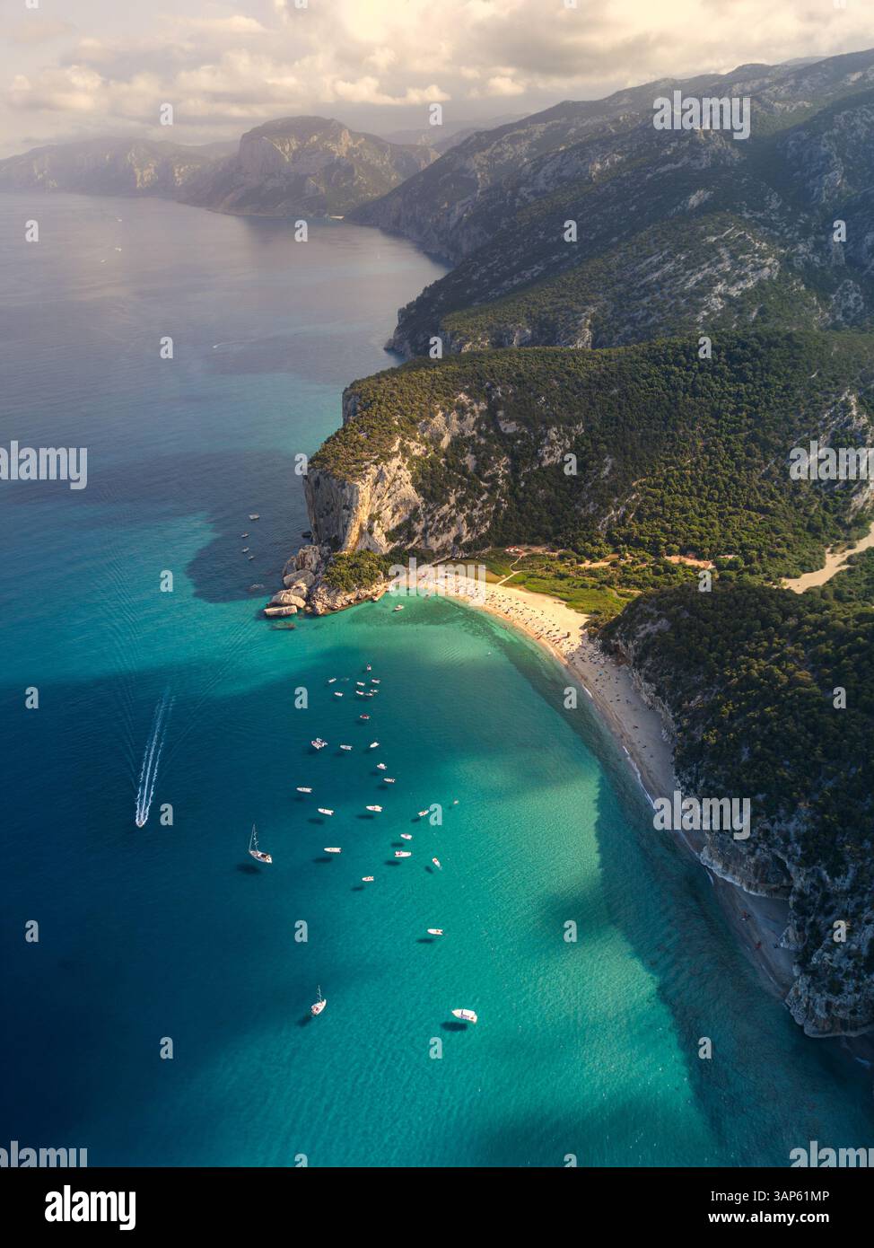 Aerial view of a few boats floating off a paradise beach in crystal ...