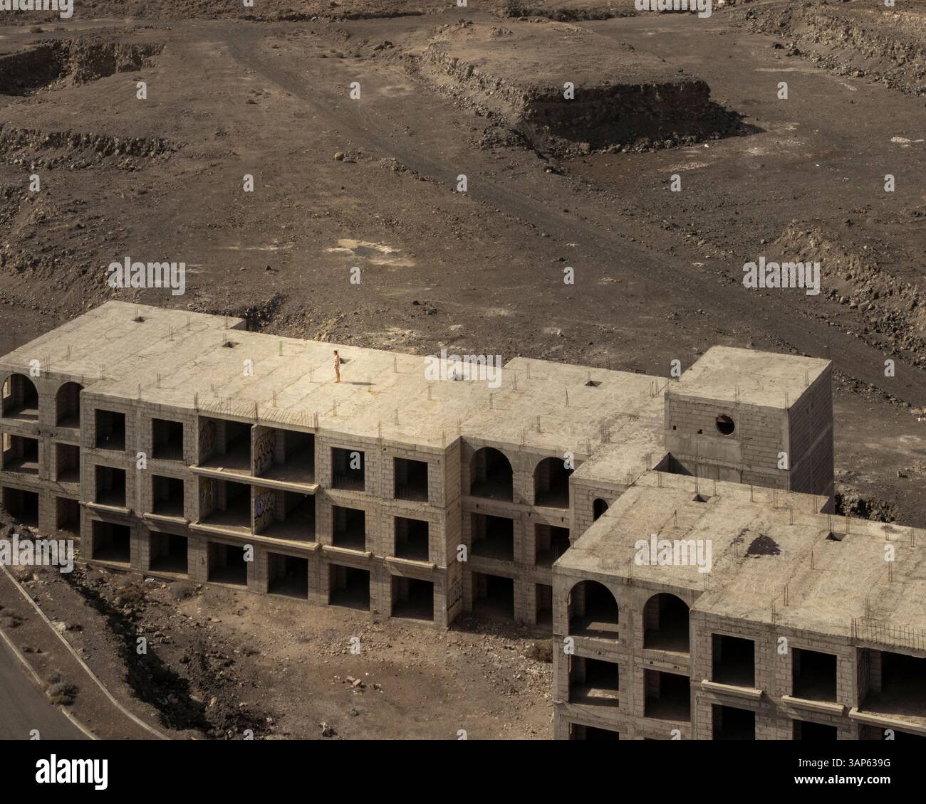 Aerial view of an abandoned concrete structure amidst a barren ...