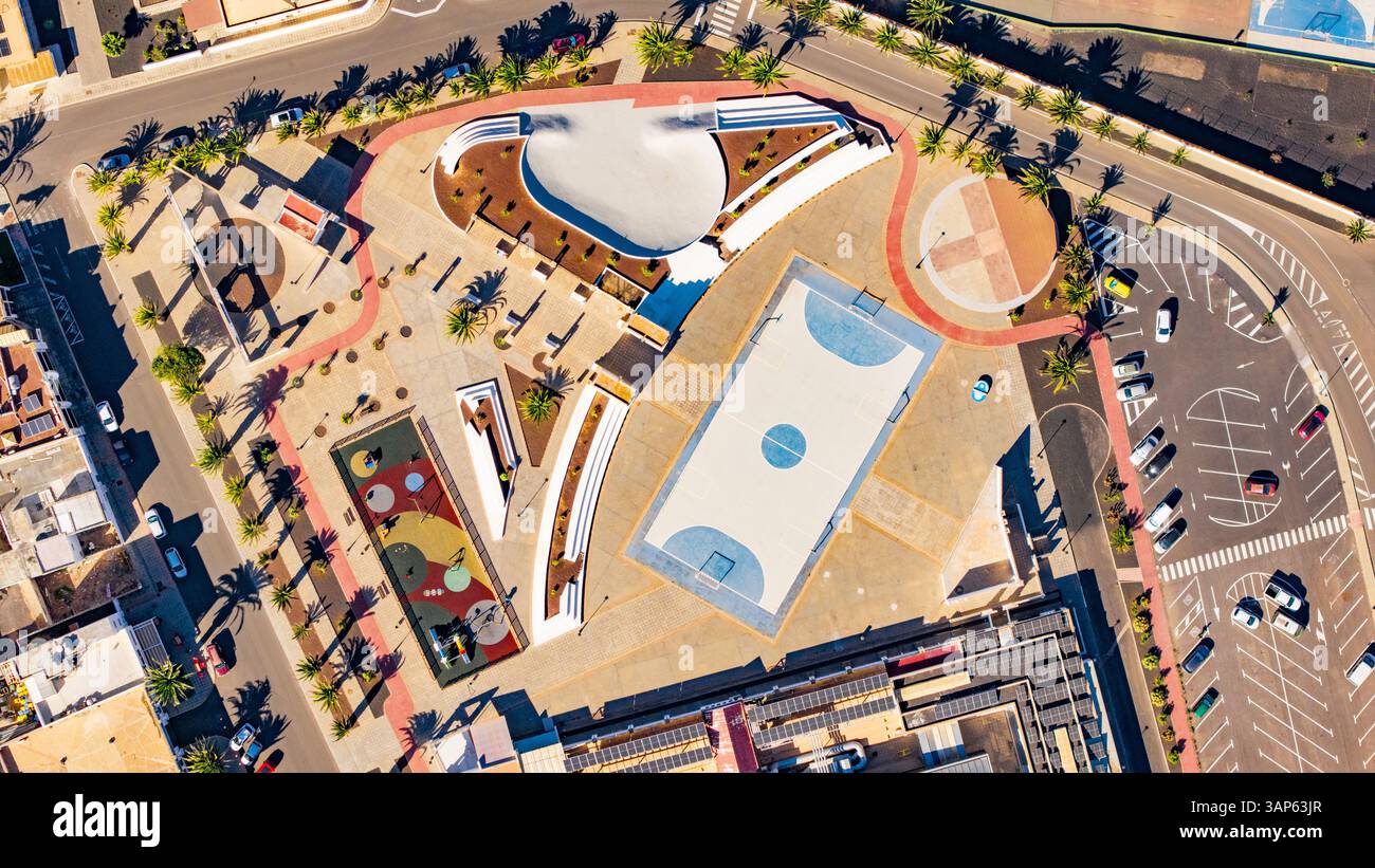 Aerial view of sports ground and traditional village with geometries ...