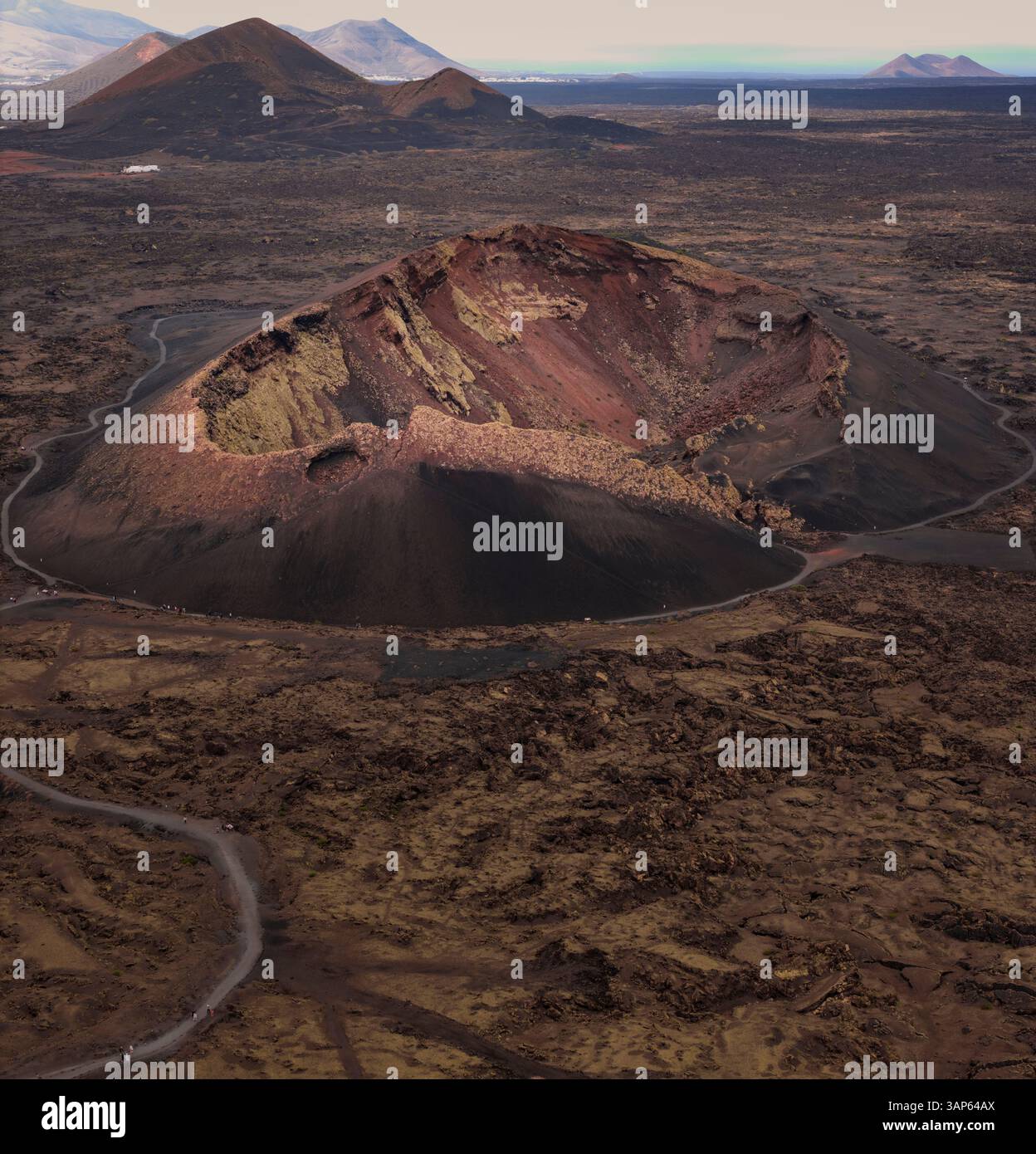 Aerial view of volcanic calderas and rugged terrain, Volcan El Cuervo ...