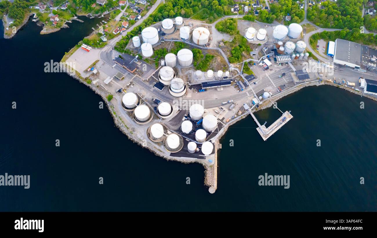 Aerial view of industrial plant and storage tanks by the pier ...