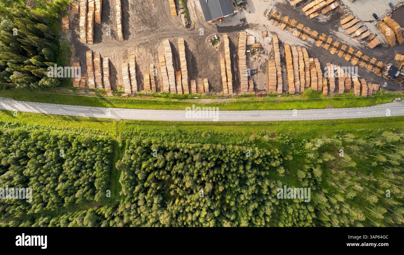 Aerial view of a wood factory surrounded by forest and logging ...