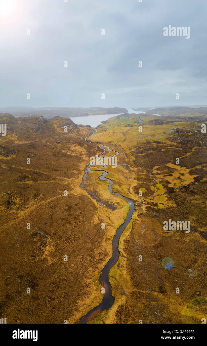 Aerial view of the winding Rhiconich River and serene Loch Inchard ...
