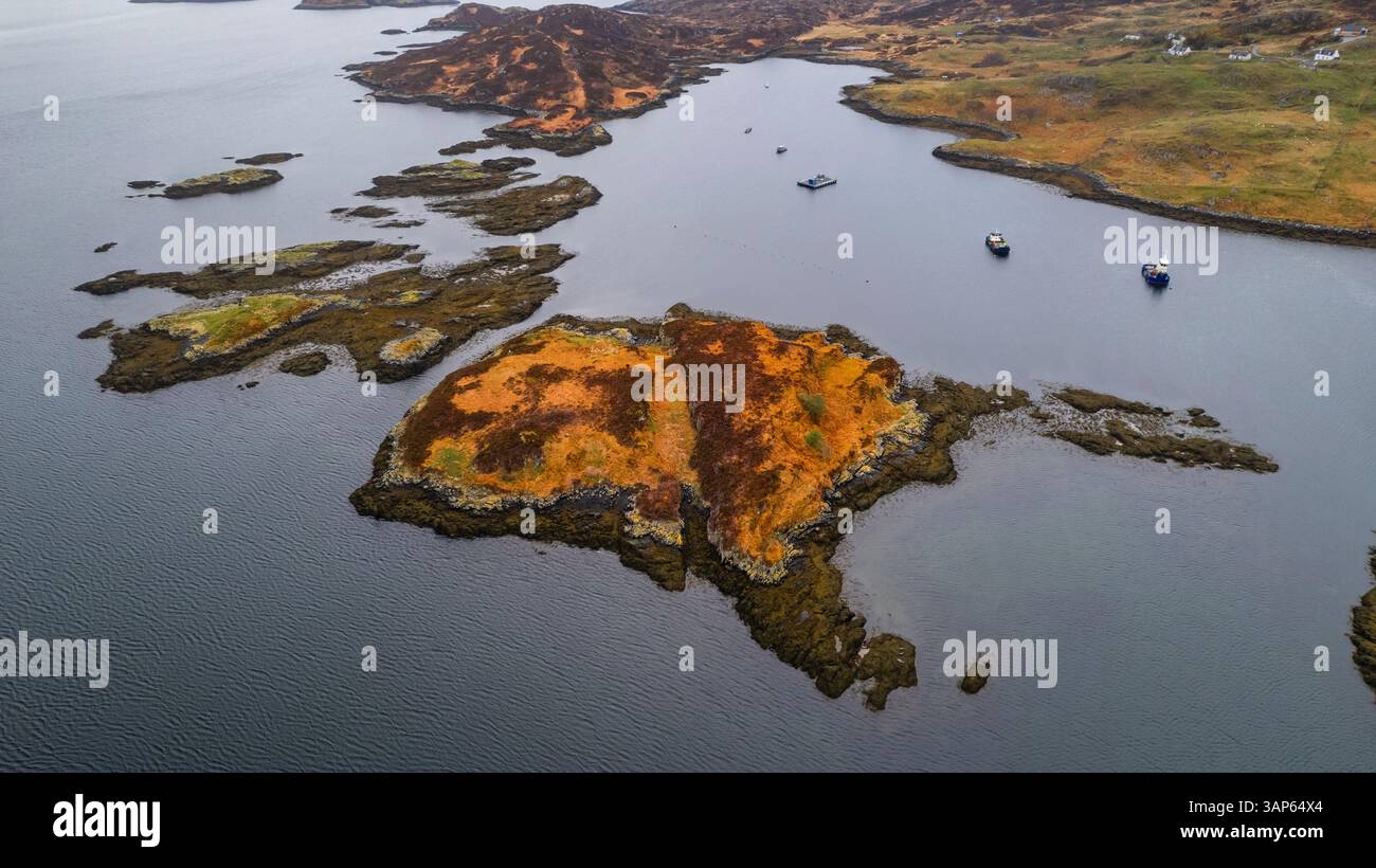 Aerial view of badcall bay with a fisherman boat and rocky shoreline ...