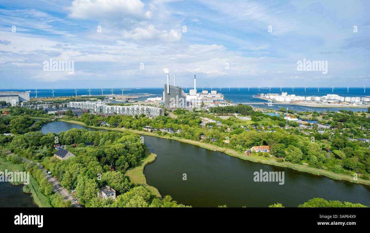 Aerial view of copenhill power plant with wind turbines and a river ...