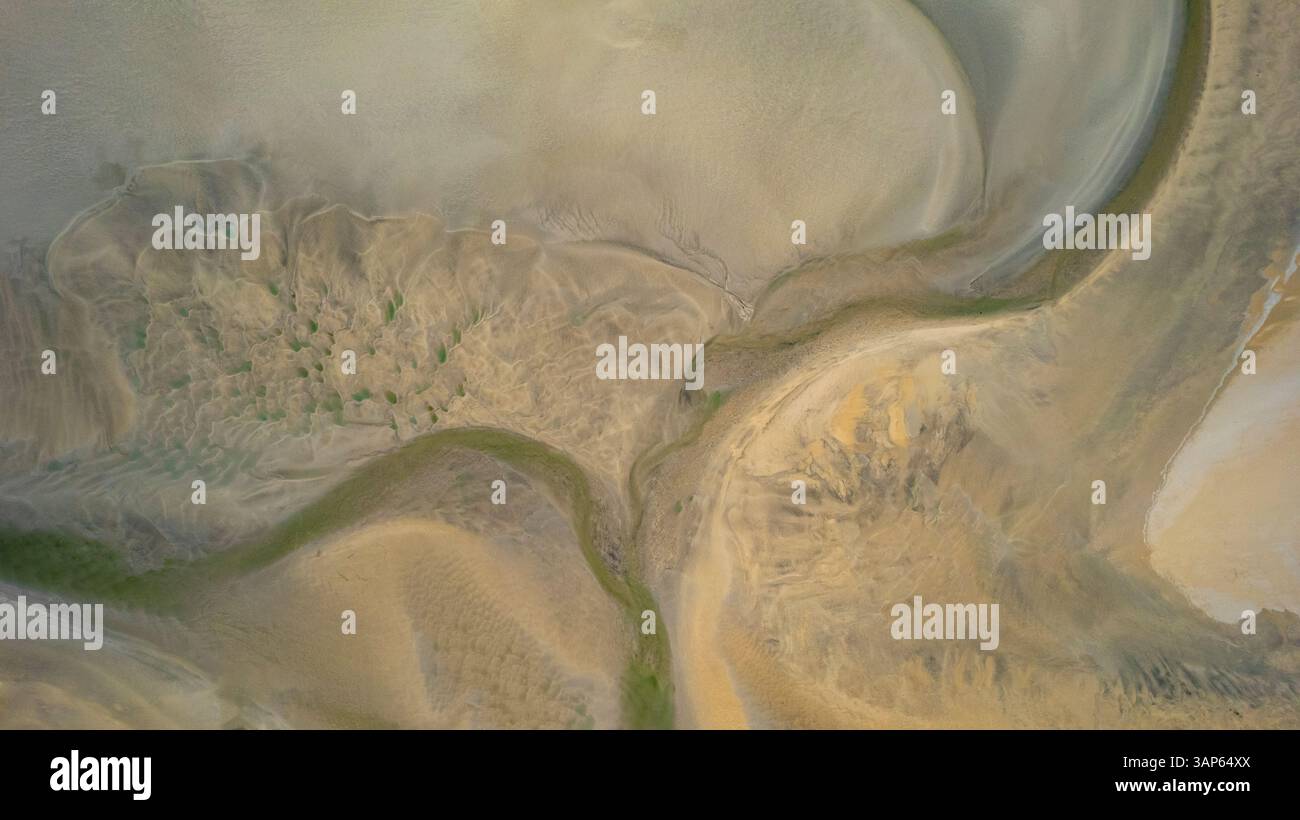Aerial view of abstract patterns on Seilebost beach with clear sand and ...