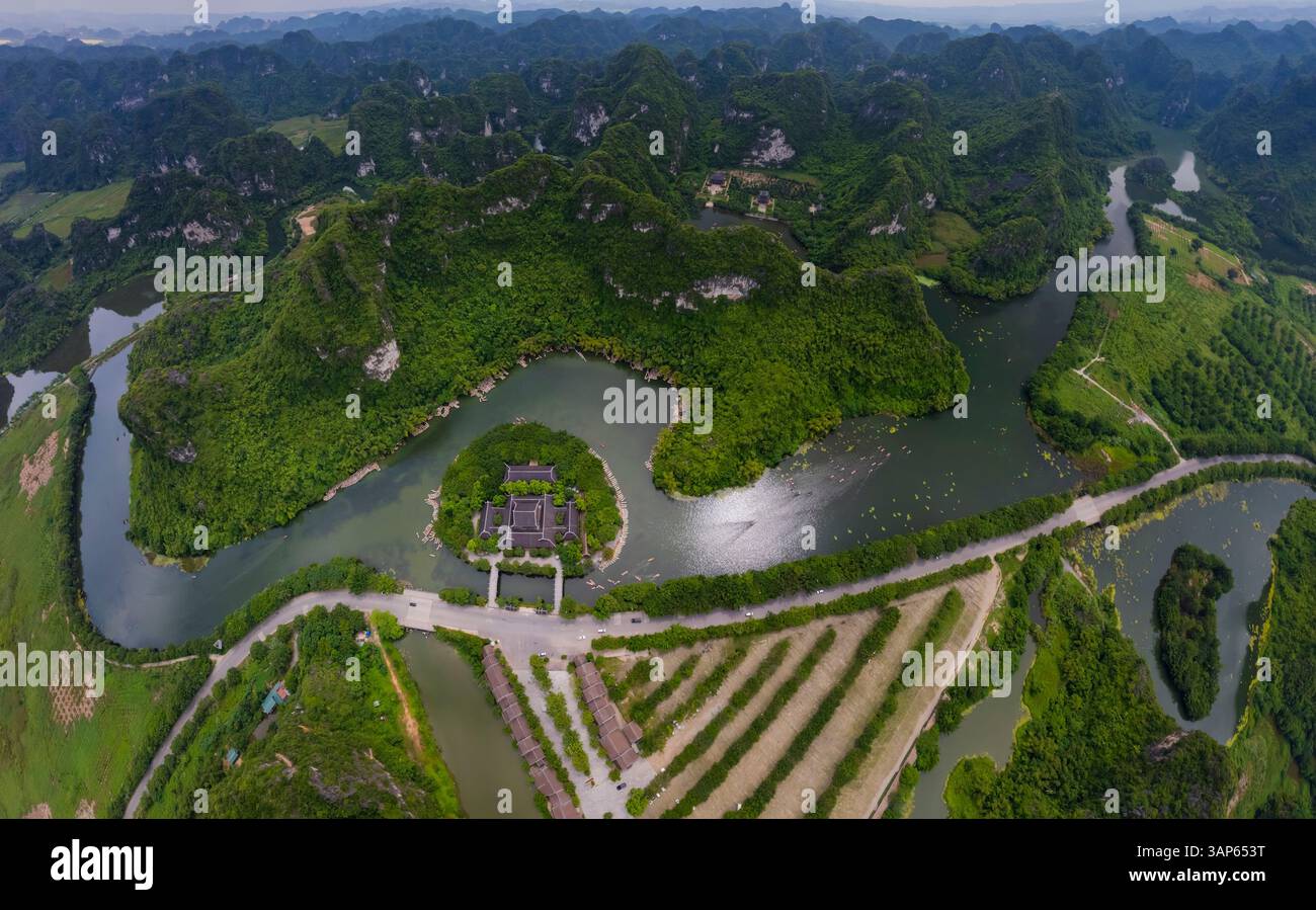 Aerial view of winding river through lush mountains and serene forest ...