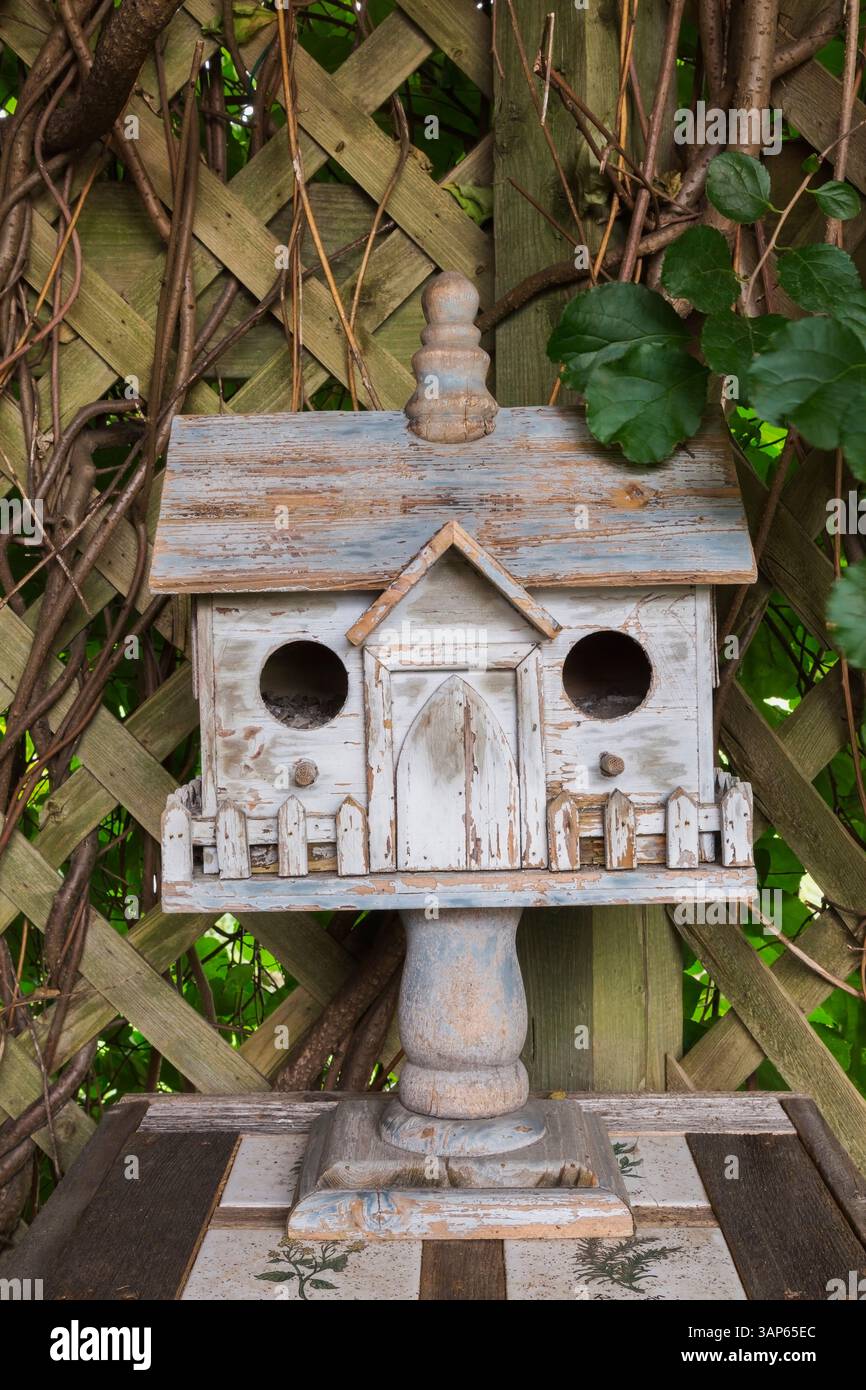 Rustic wooden birdhouse on a stand inside gazebo in backyard country ...