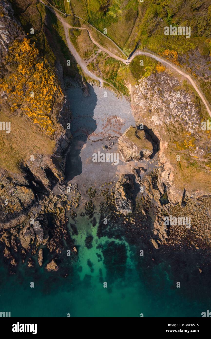Aerial view of a narrow bay with cliffs facing the Irish Sea along ...