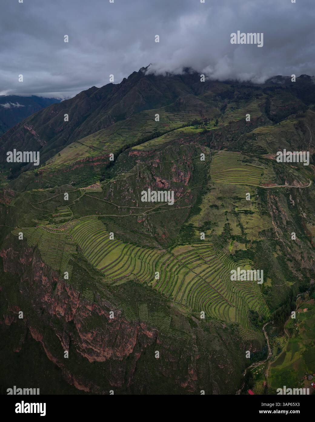 Aerial view of agricultural landscape with mountain peaks in Pisac ...