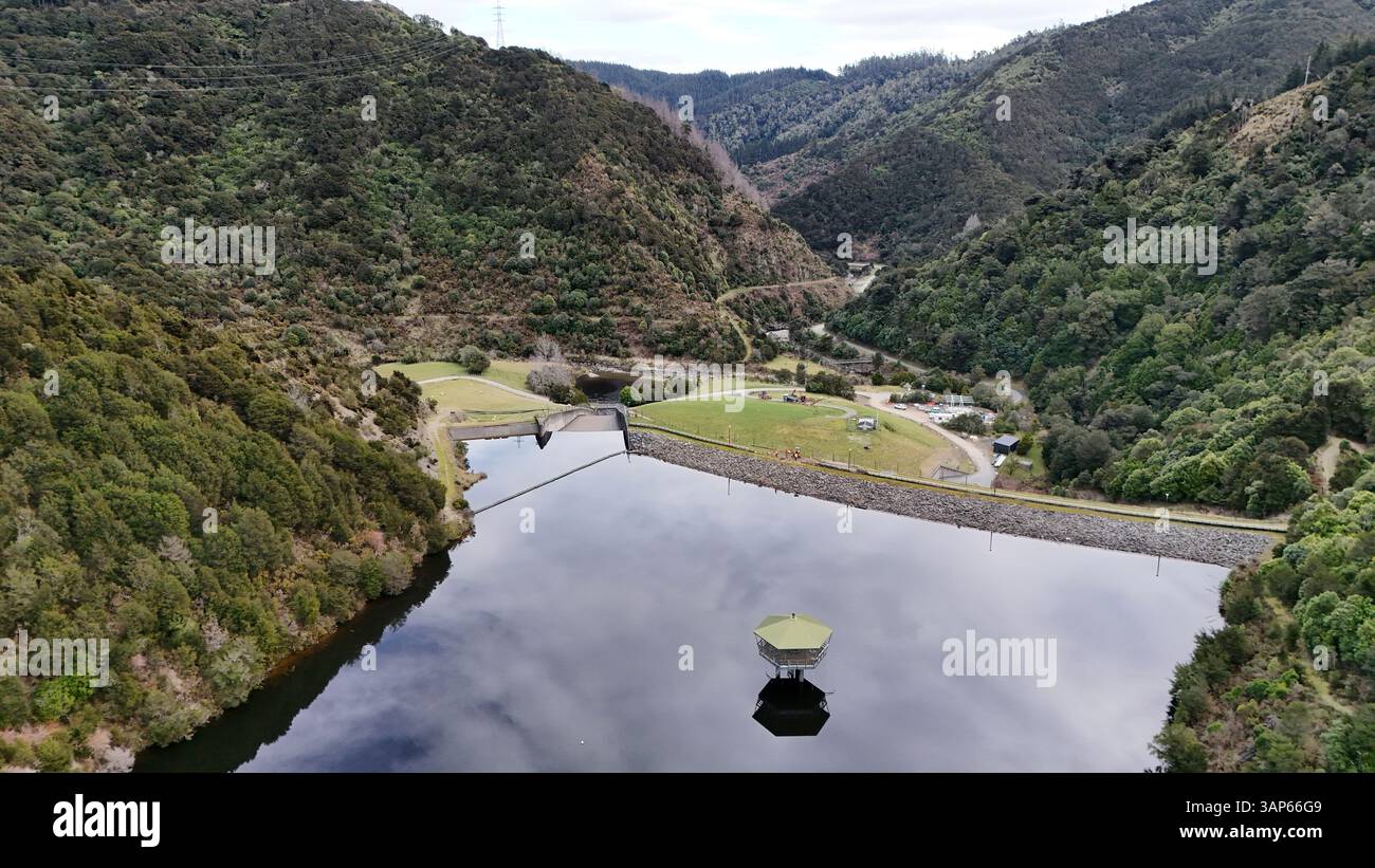 Aerial view of a serene river winding through a lush valley surrounded ...