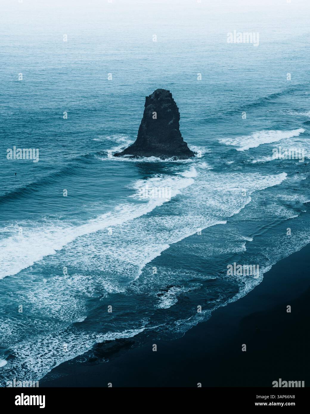 Aerial view of the beautiful black sand beach with dramatic rock ...