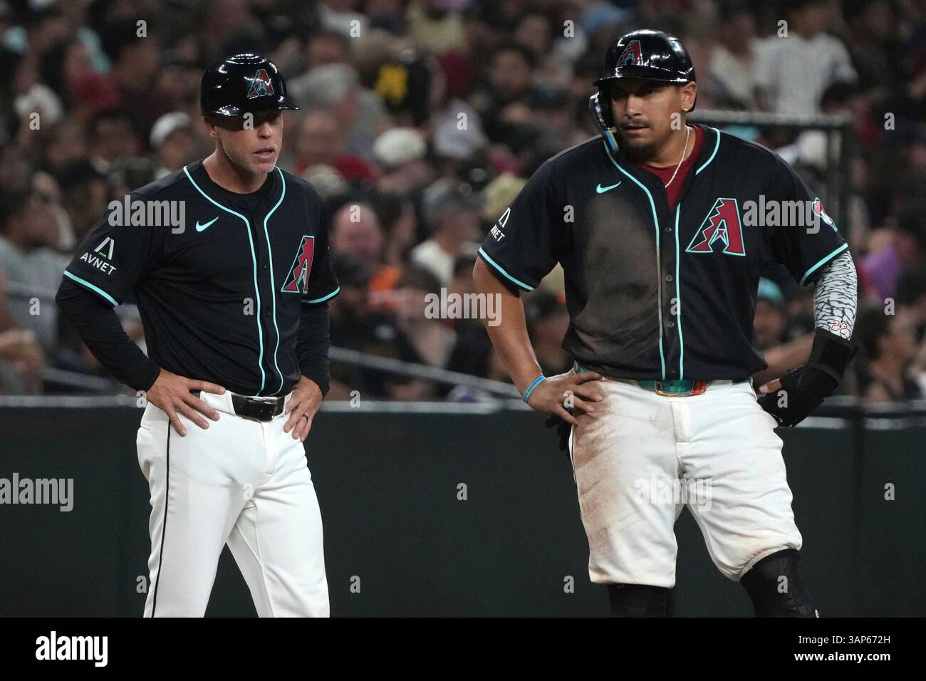 Arizona Diamondbacks third base coach coach Shaun Larkin (88) and first ...