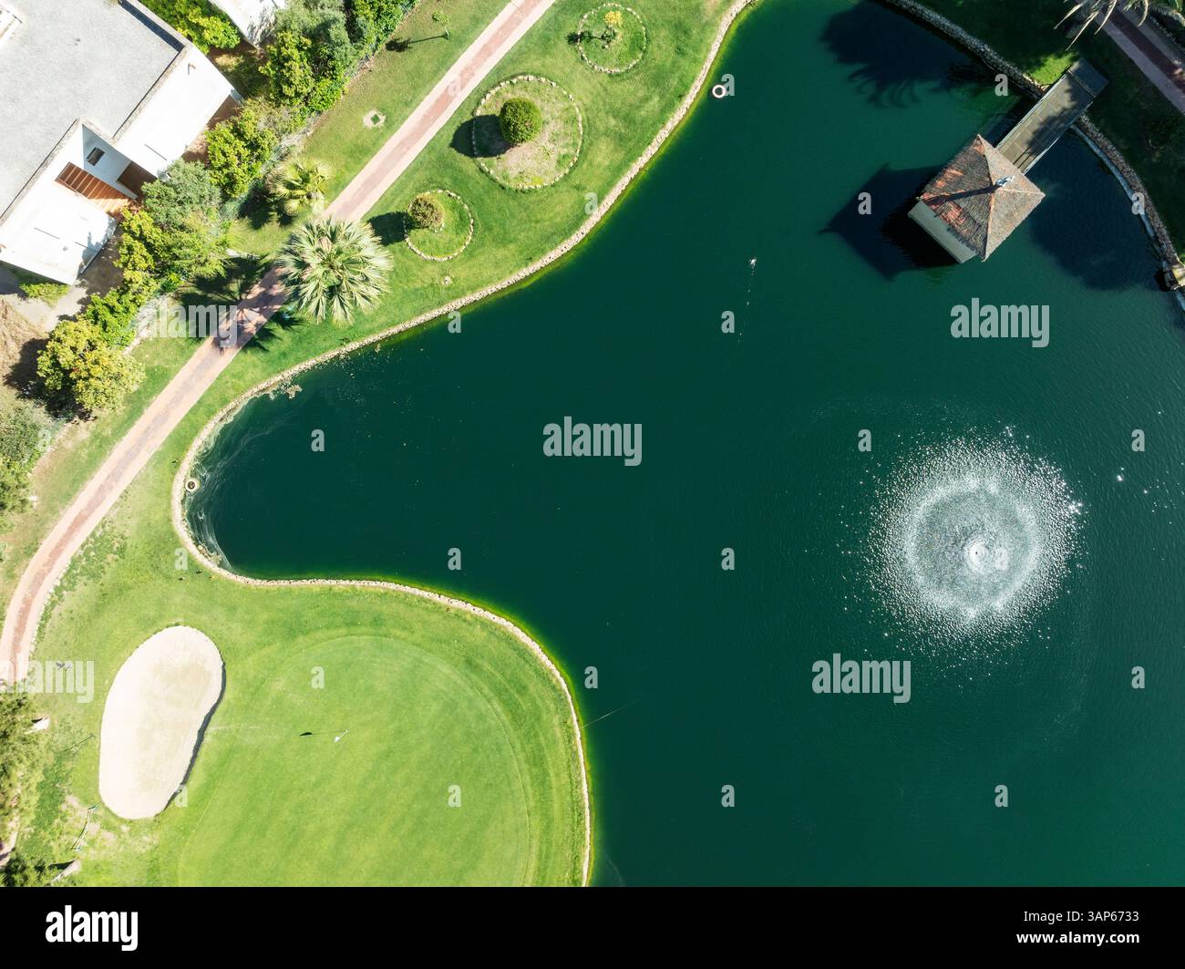 Aerial view of La Noria Golf Resort with serene lake, tranquil fountain ...