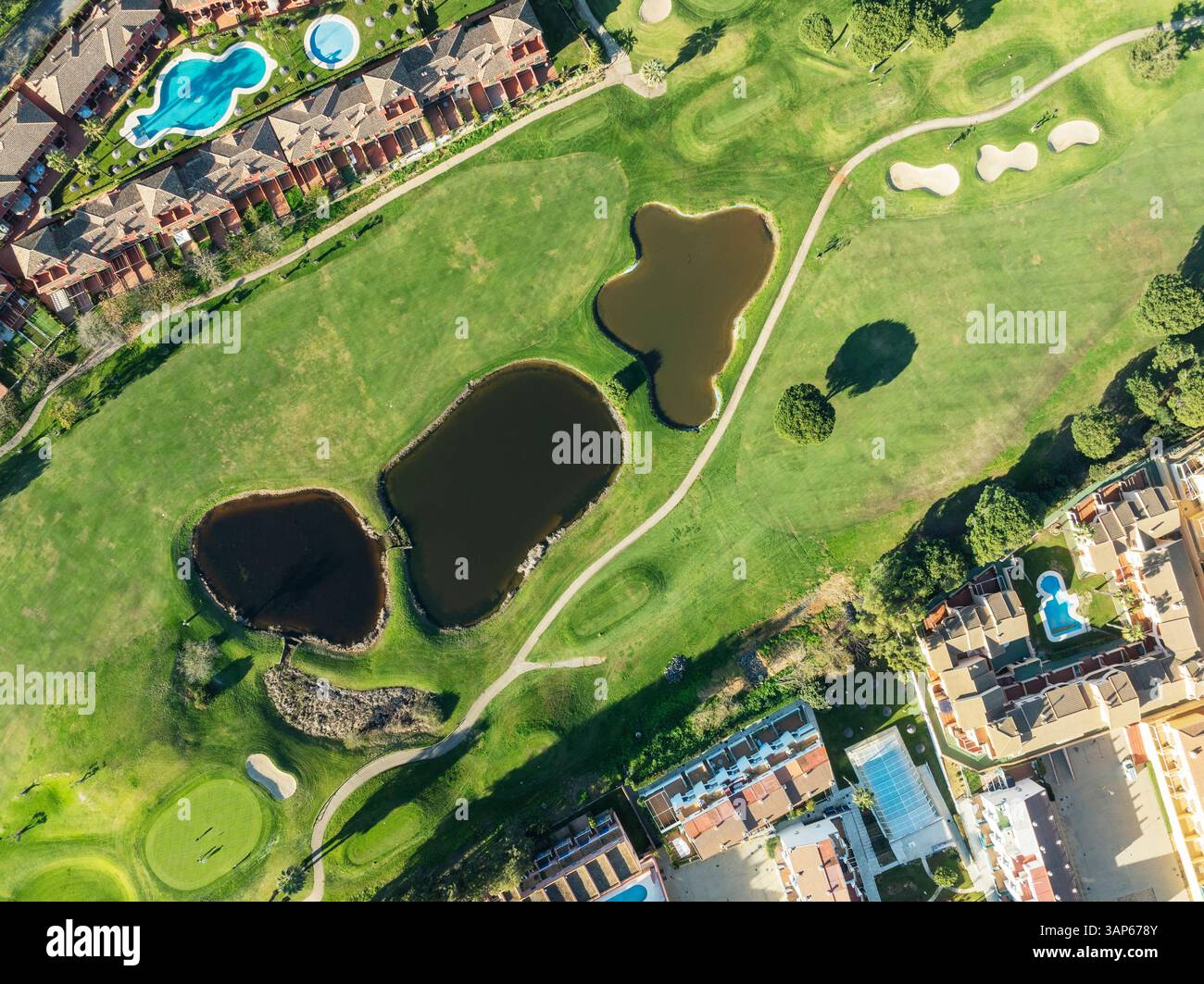 Aerial view of Islantilla Golf Resort with beautiful golf course, ponds ...