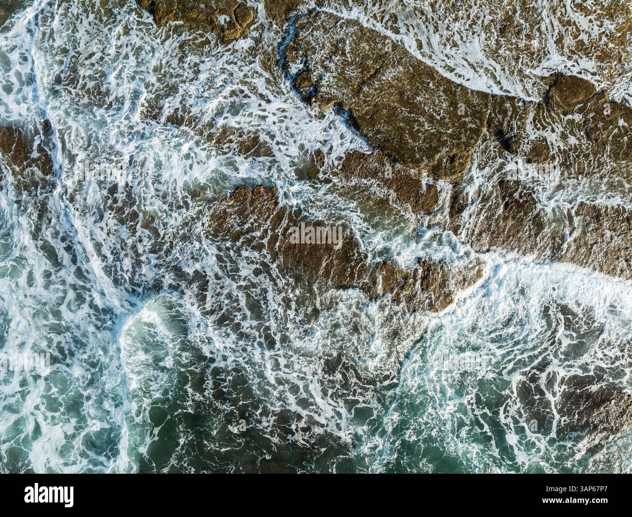 Aerial view of the beautiful rugged coastline with dynamic waves and ...
