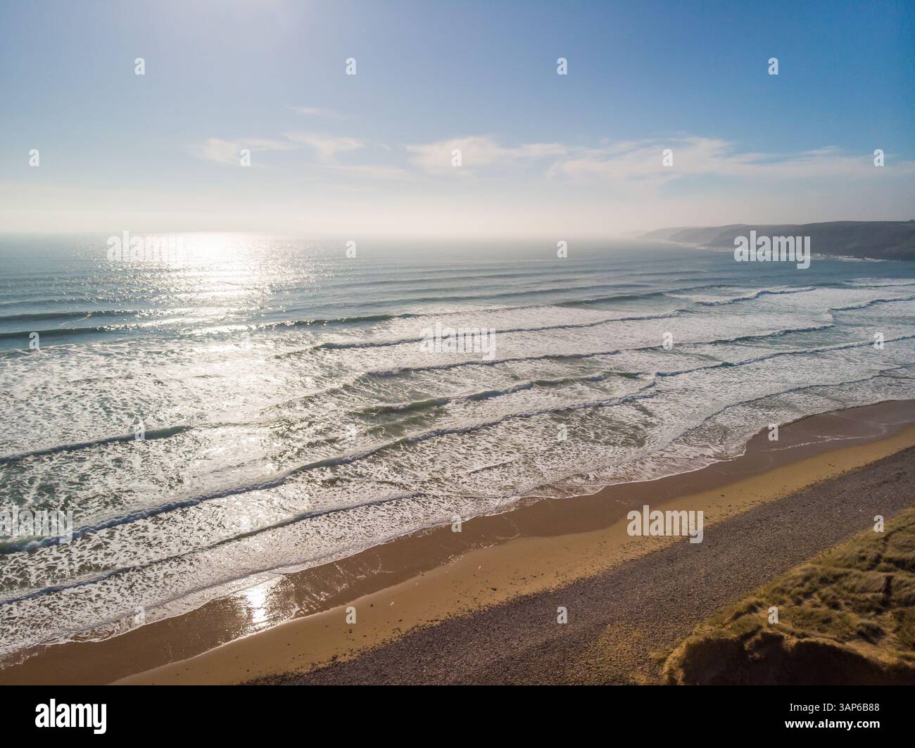 Aerial view of gentle waves in the afternoon sun, on Freshwater West ...