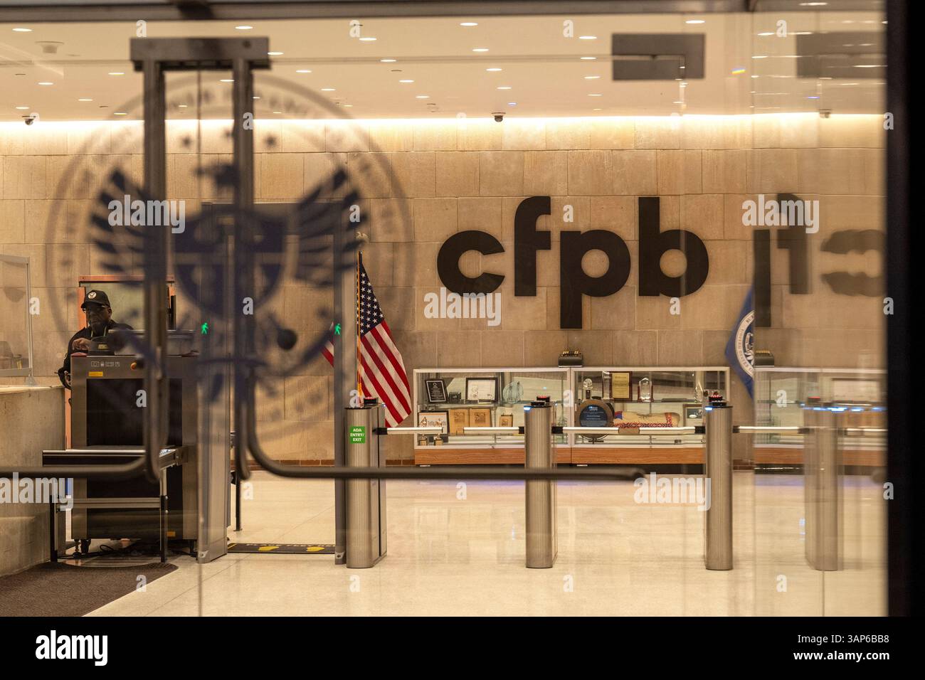 FILE - A security officer works inside of the Consumer Financial ...