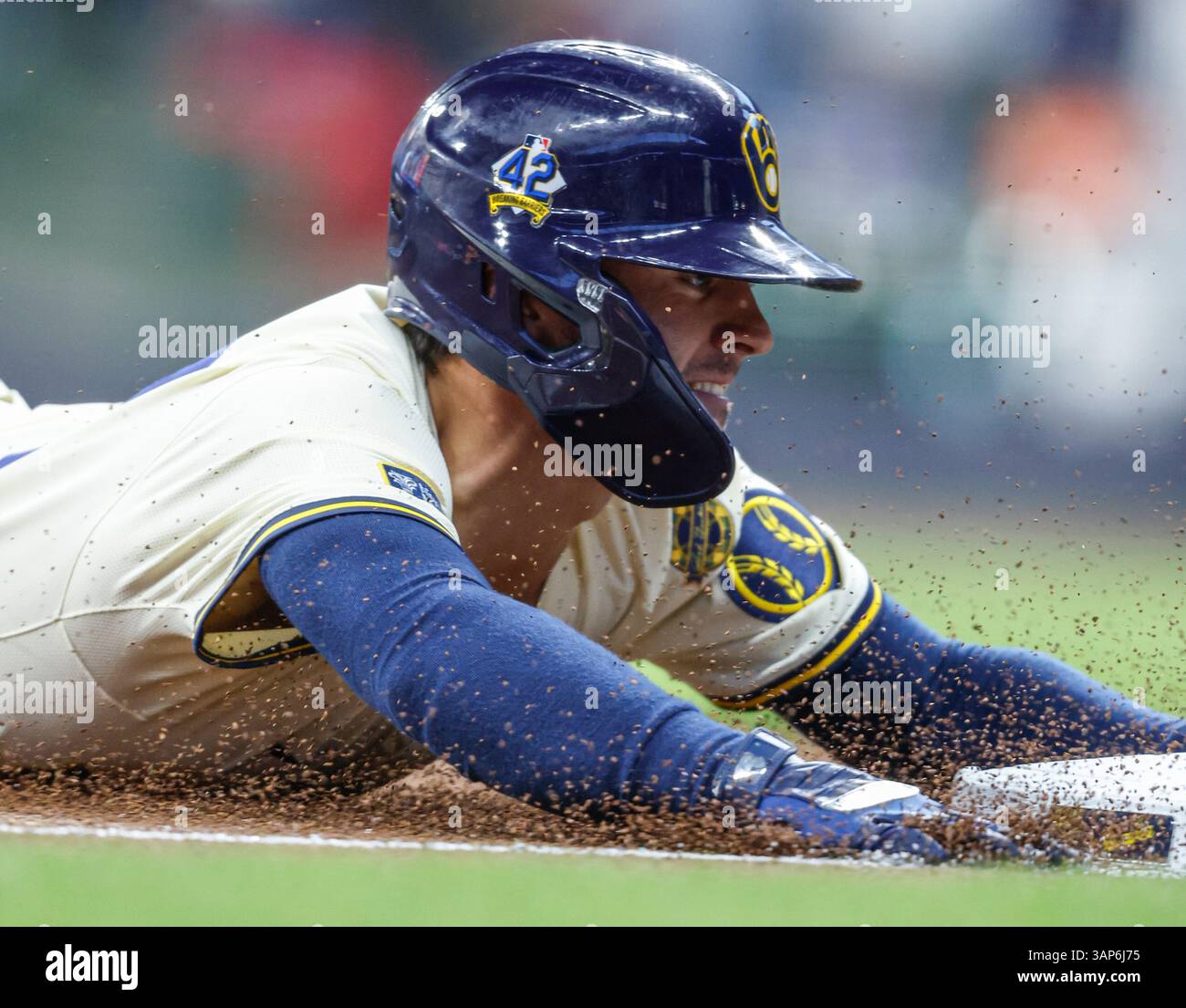 Milwaukee Brewers' Sal Frelick slides into third base during his triple ...