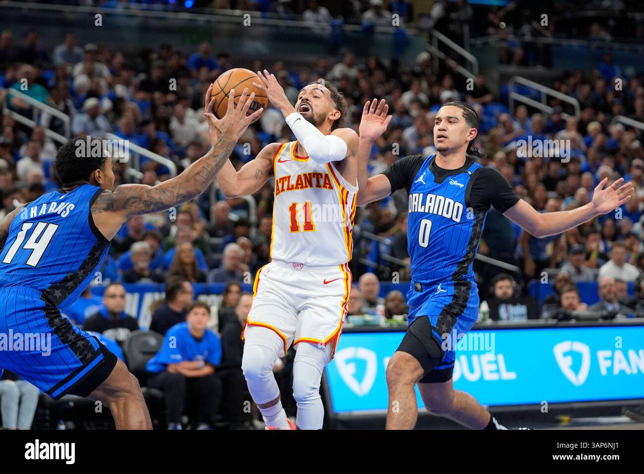 Atlanta Hawks guard Trae Young (11) attempts a shot as he goes between ...