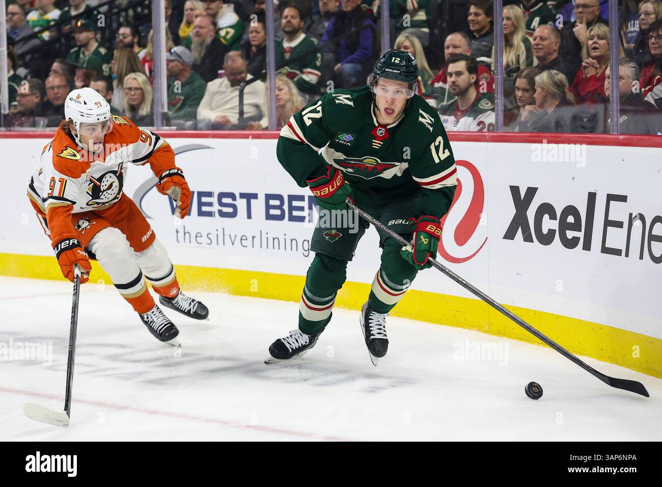 Minnesota Wild left wing Matt Boldy, right, skates with the puck as ...